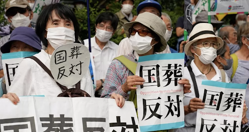 A divided Japan bids farewell to its slain ex-PM